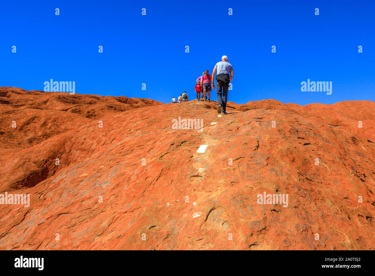 Uluru, Northern Territory, Australia - Aug 23, 2019: people descend ...