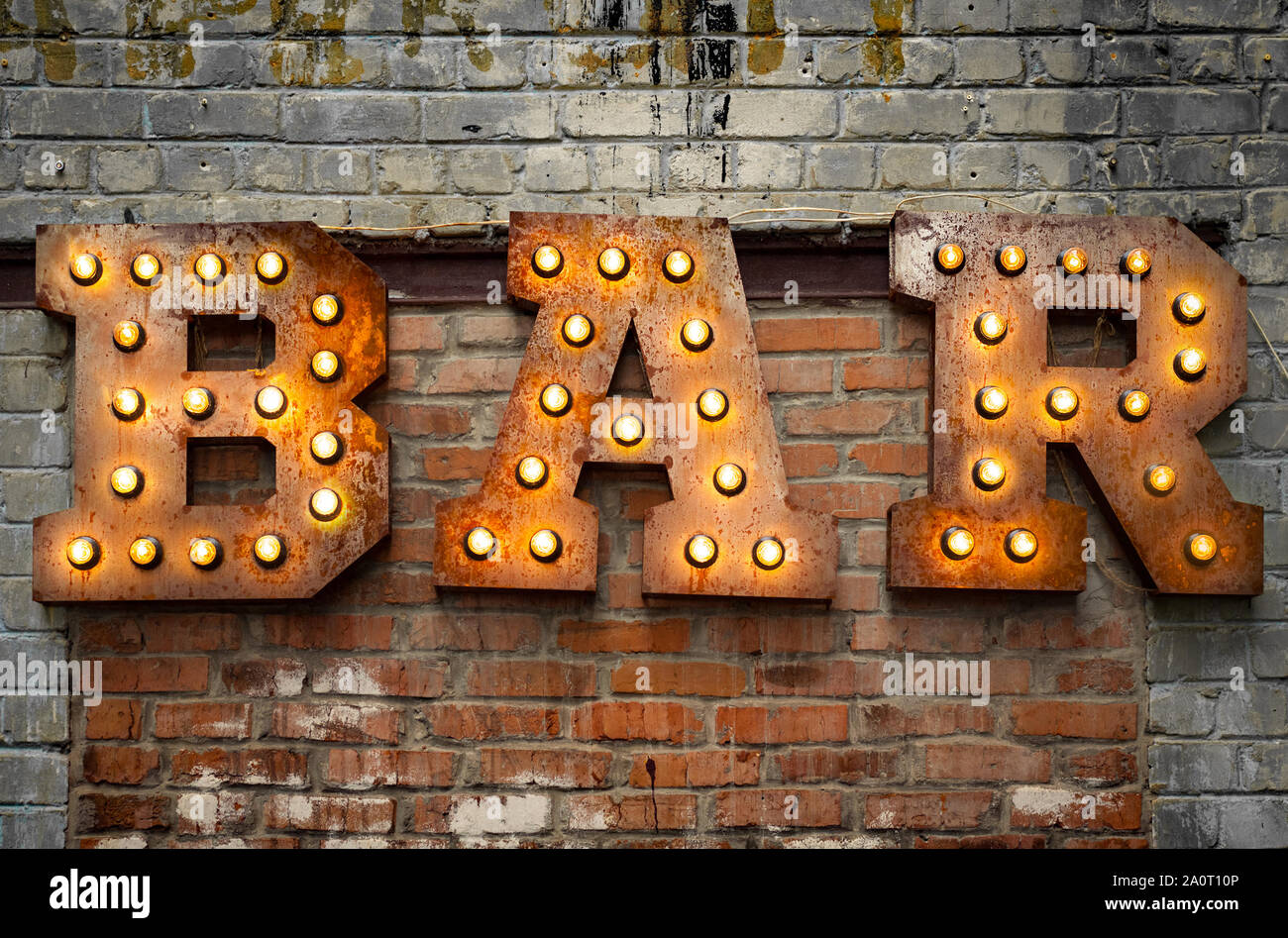 Bar signboard. Inscription from large metal letters decorated with ...