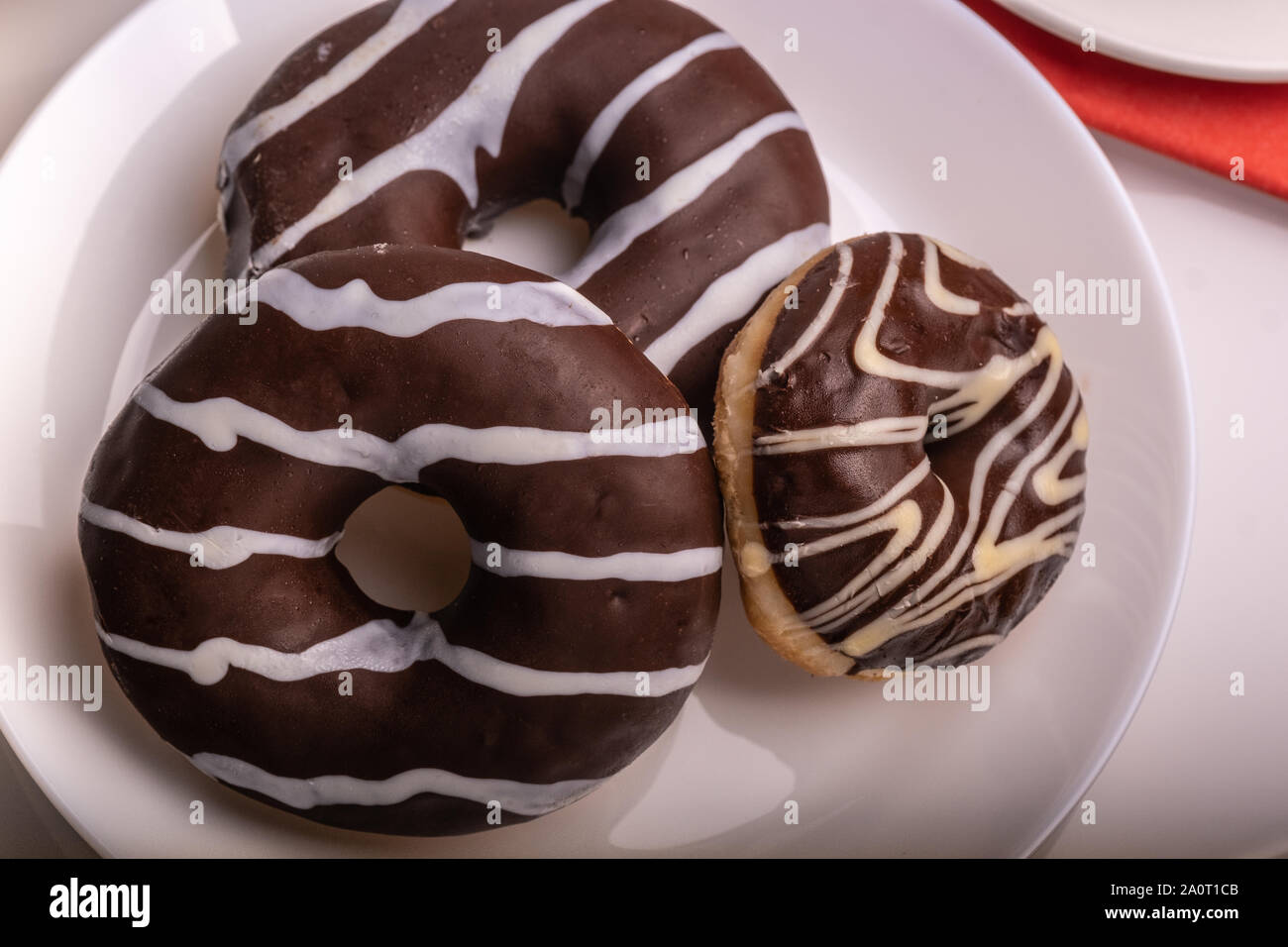 Three donuts in chocolate hi-res stock photography and images - Alamy