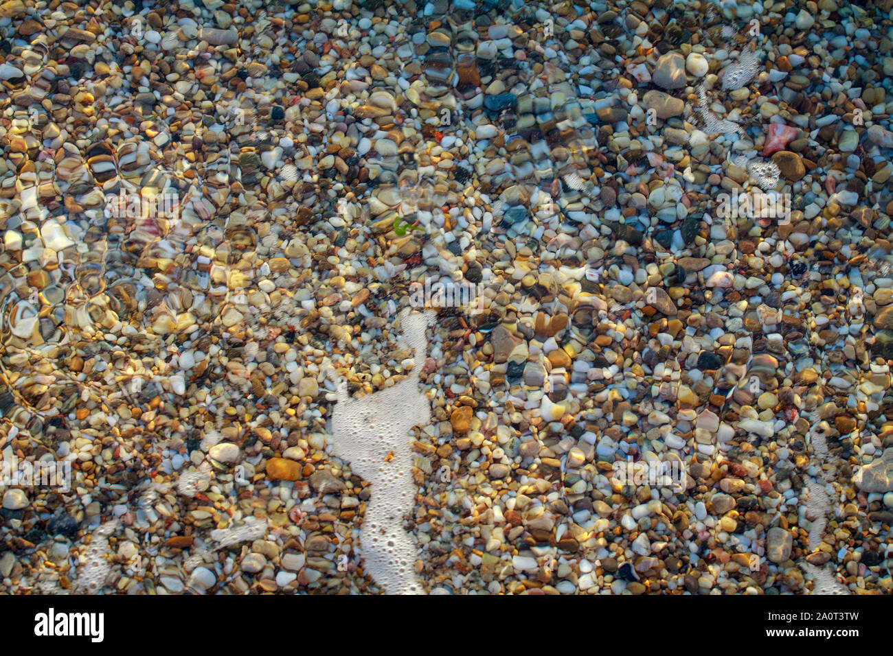 sea pebbles colored granite on the beach background stones. The shore ...