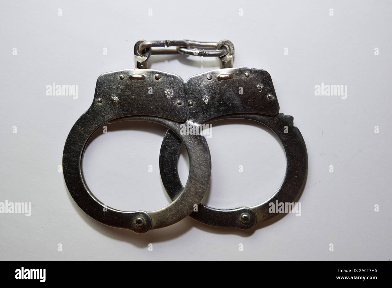 handcuffs steel isolated on white background Stock Photo - Alamy