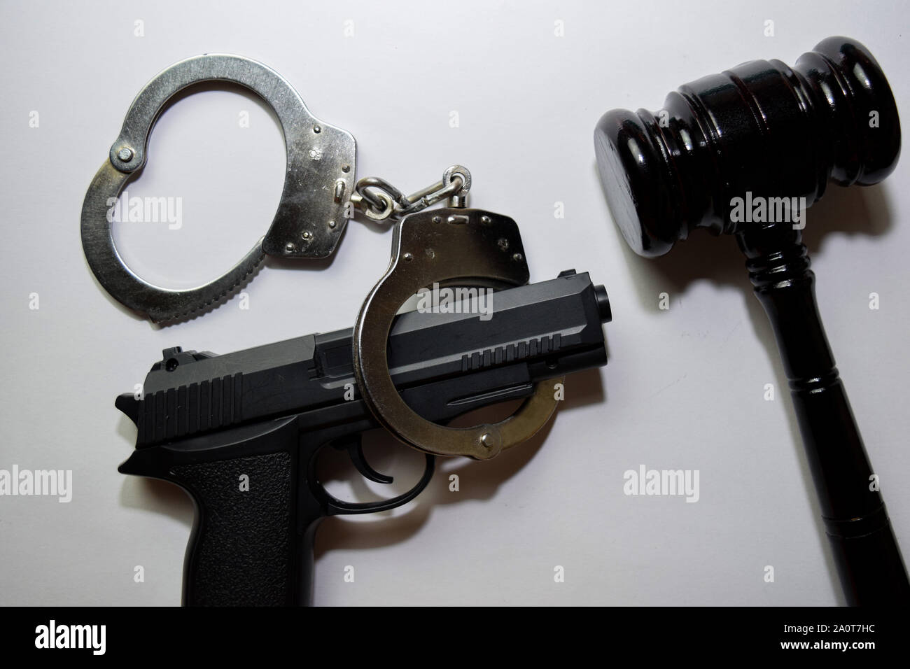 gun, handcuffs and black gavel isolated on white background. Justice ...