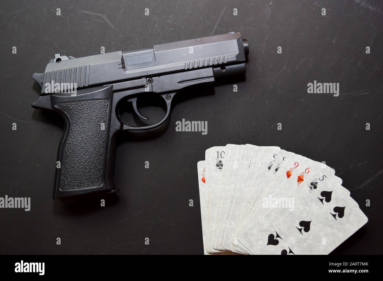 set of playing cards and gun isolated on black background. casino ...