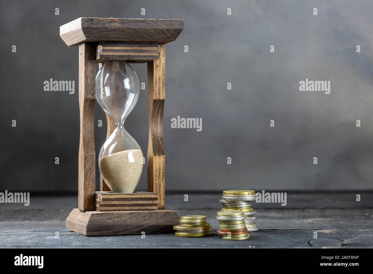 time is money concept, coin and hourglass Stock Photo - Alamy