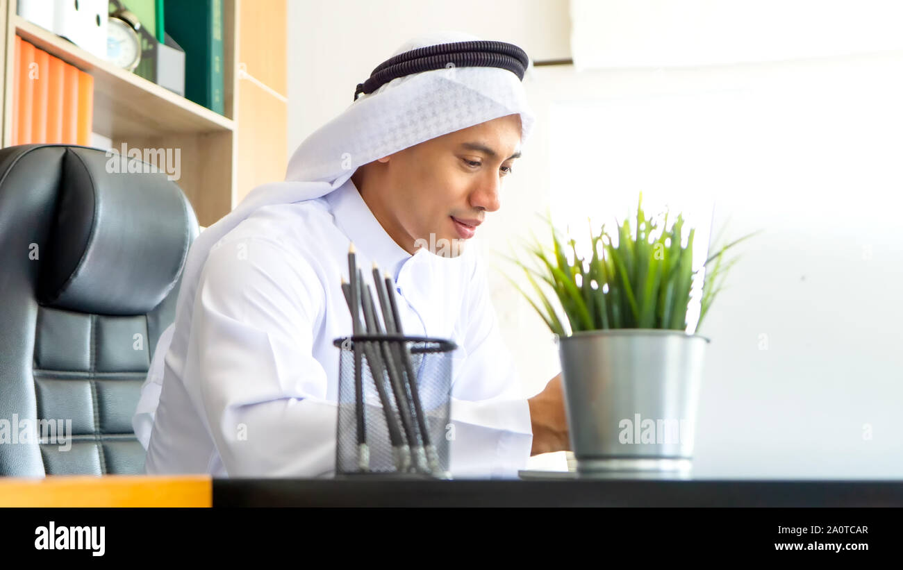 portrait of Muslim man sitting in office Stock Photo - Alamy