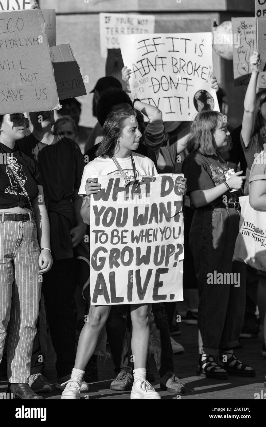 Gen Z protesters hold up signs to passing cars at the International ...