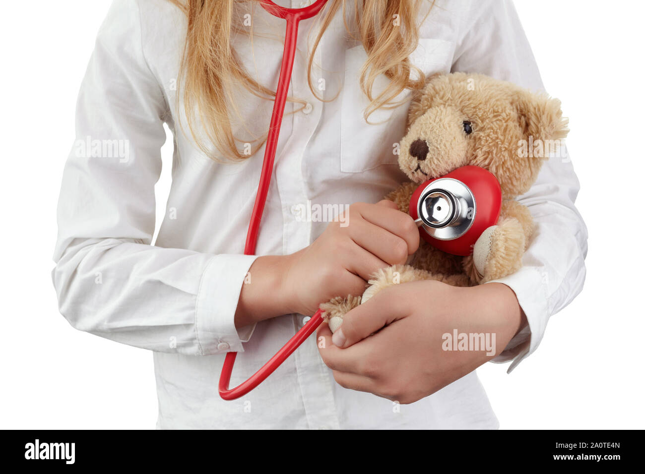Kid girl playing doctor with plush toy as nursery on white background ...