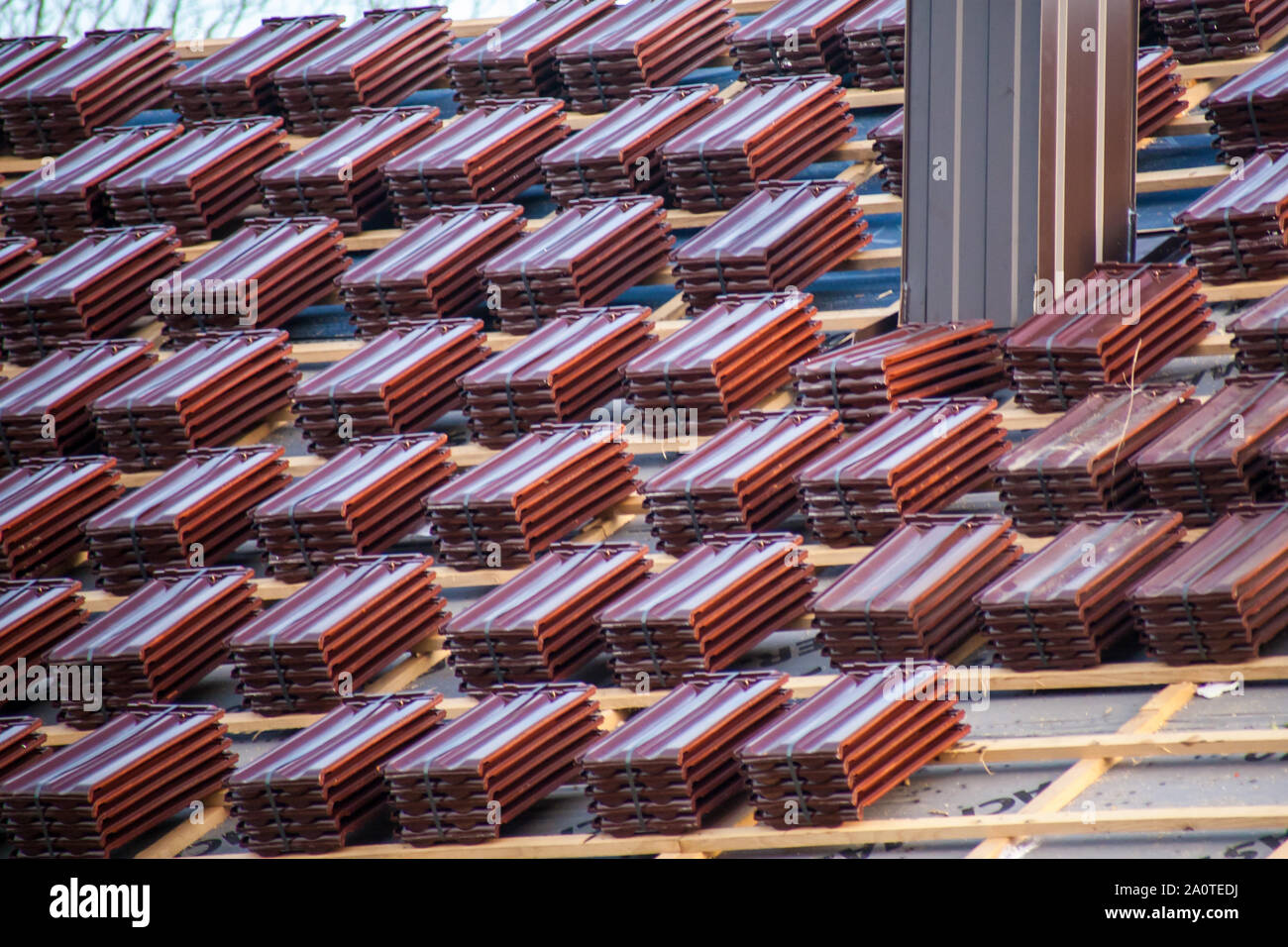 Red tile packs on the roof ready to tile the roof. Technology Weather ...
