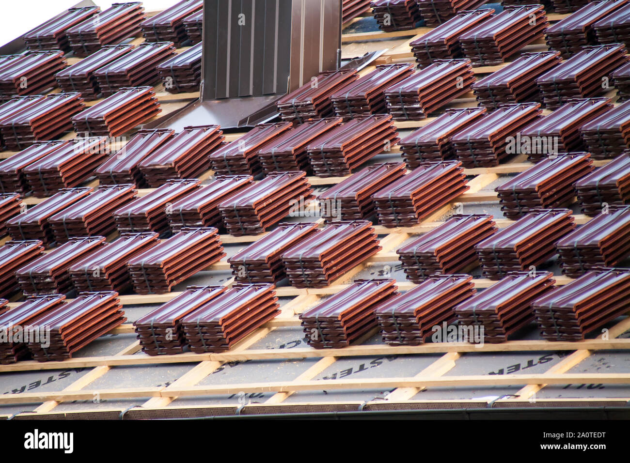 Red tile packs on the roof ready to tile the roof. Technology Weather ...