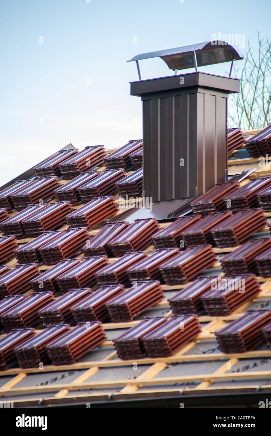 Red tile packs on the roof ready to tile the roof. Technology Weather ...