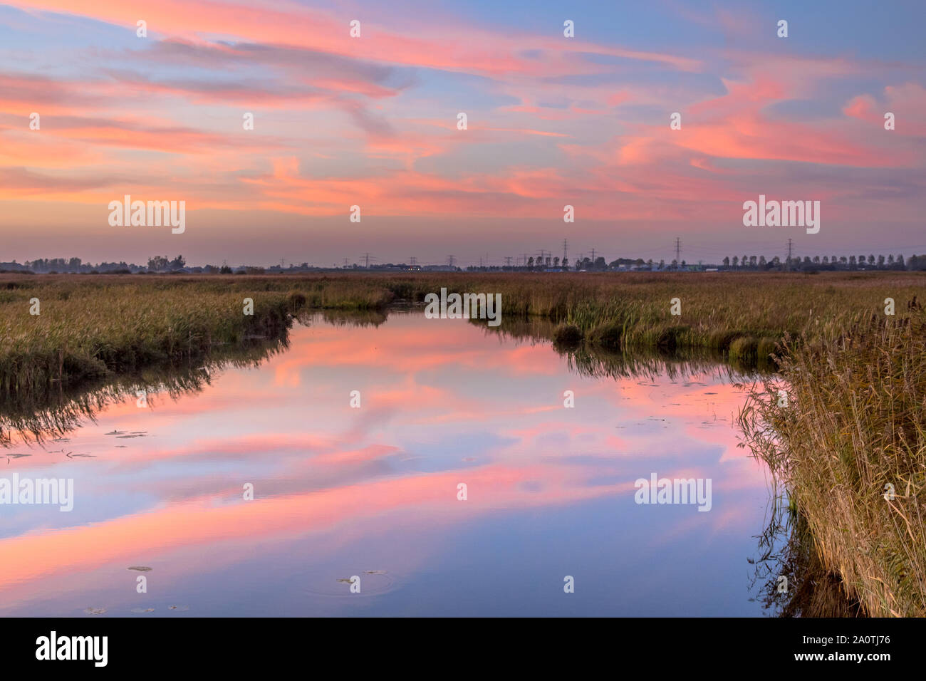 River through marshland under beautiful sunset, Groningen, Netherlands ...