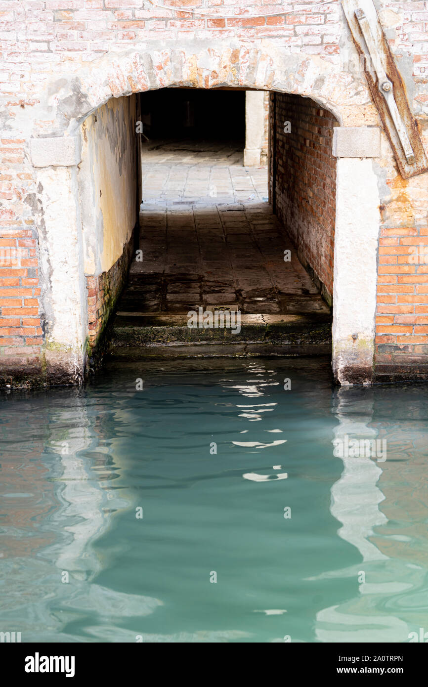 Low arch entrance to a building on a narrow canal, Venice, Italy Stock ...