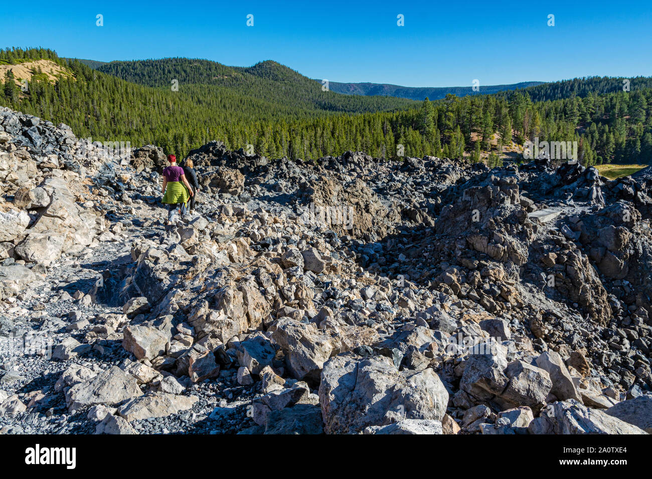 Oregon, Newberry National Volcanic Monument, Big Obsidian Flow Trail, two female hikers Stock ...