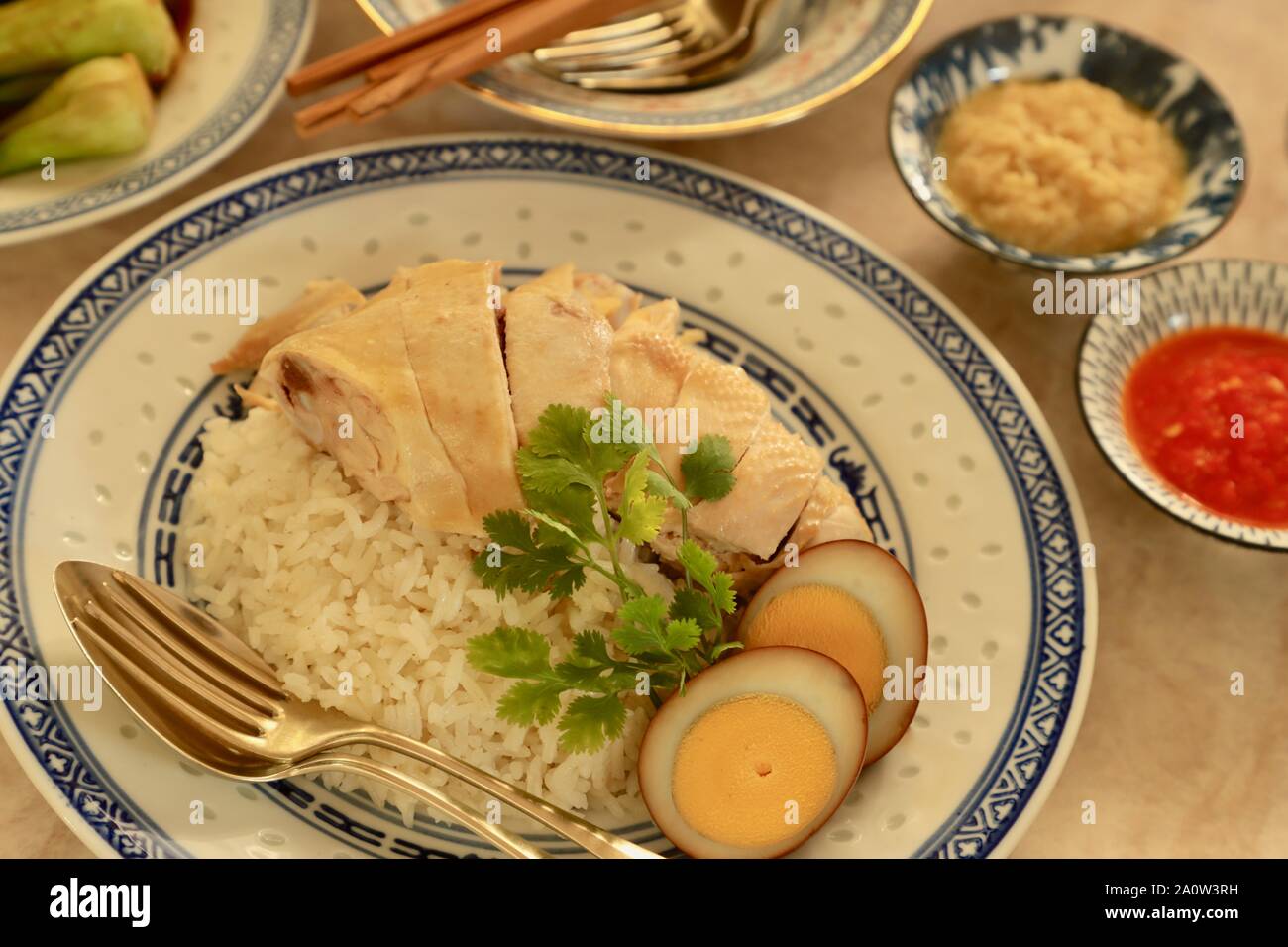 Hainanese Chicken Rice. Fragrant rice cooked in chicken broth; then ...