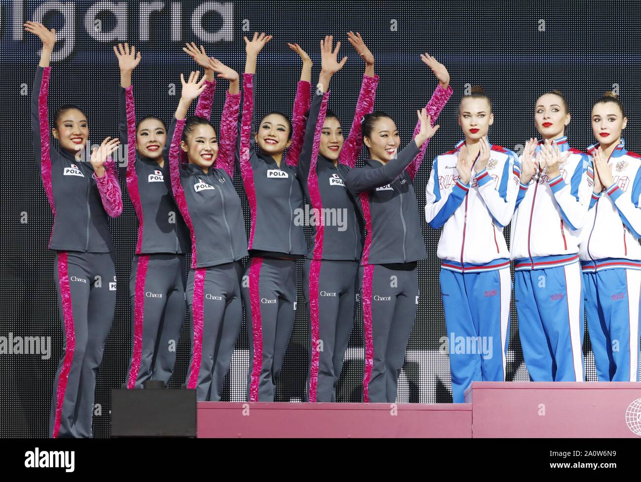 Members of Japan women's rhythmic gymnastics team, known as Fairy Japan, wave after winning ...