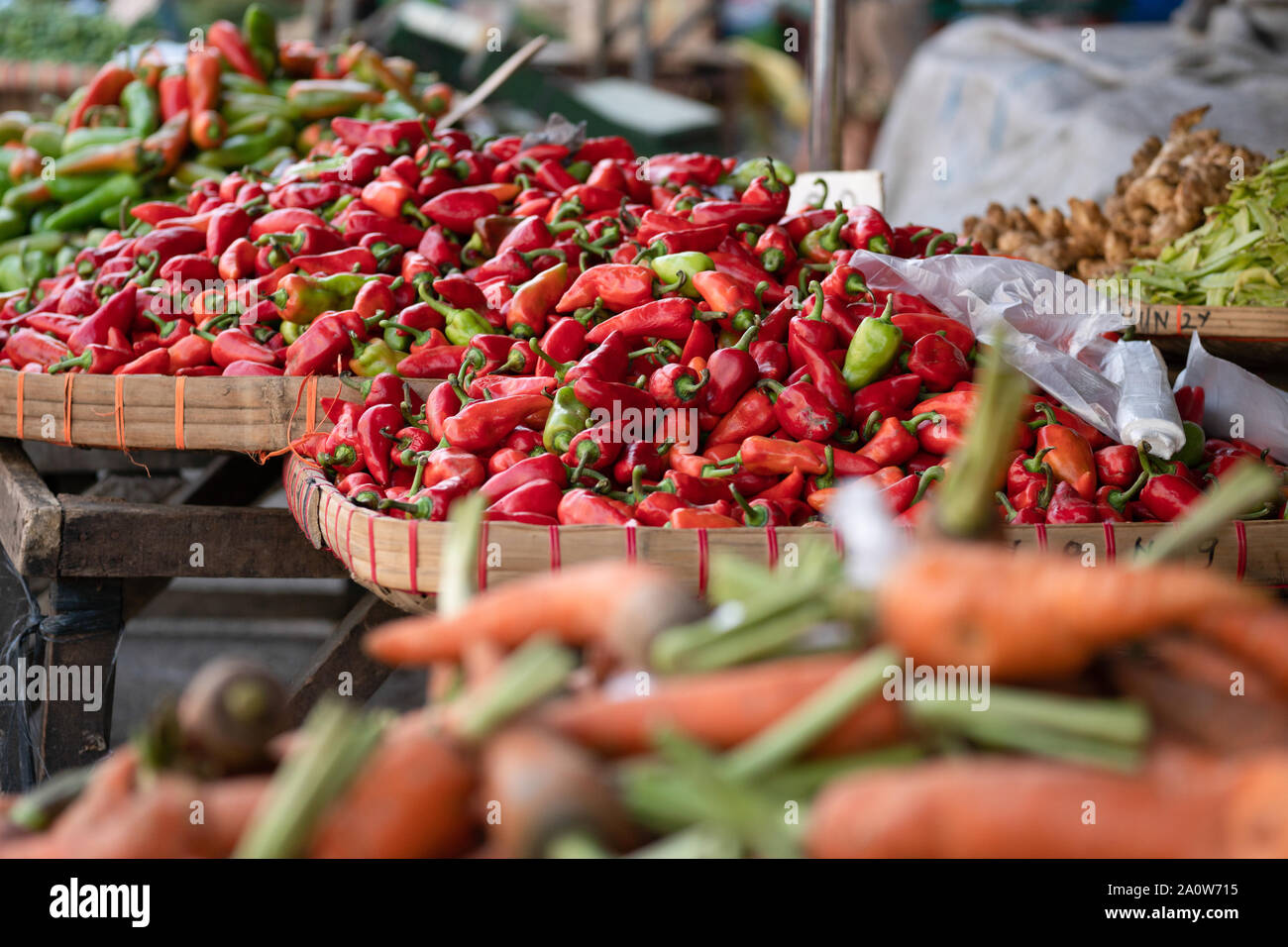Display of colourful red bell pepper vegetables on display in a street ...