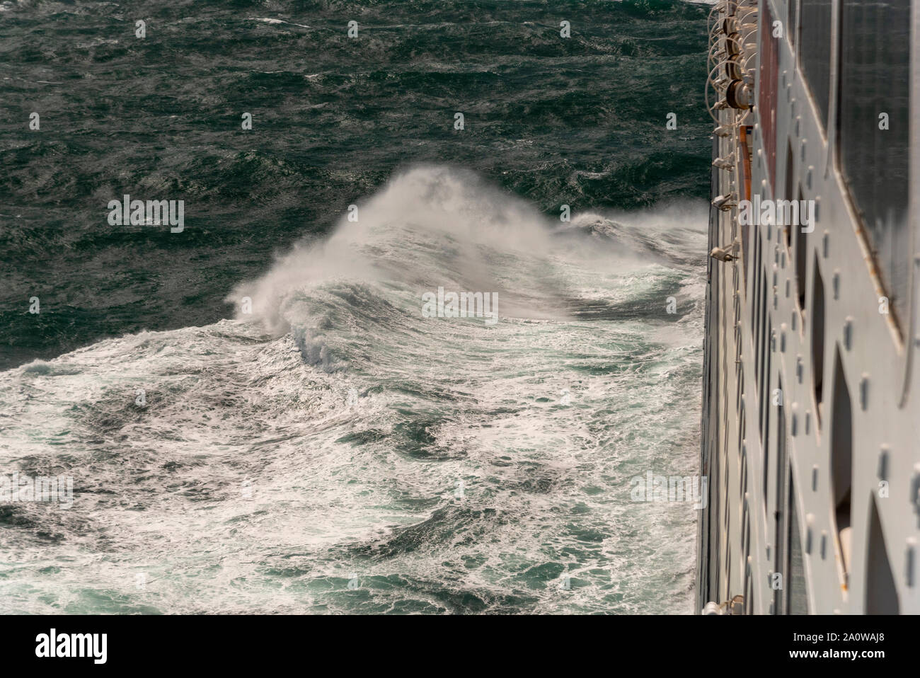 Looking along the side of Queen Mary 2 at black water of the North Sea ...