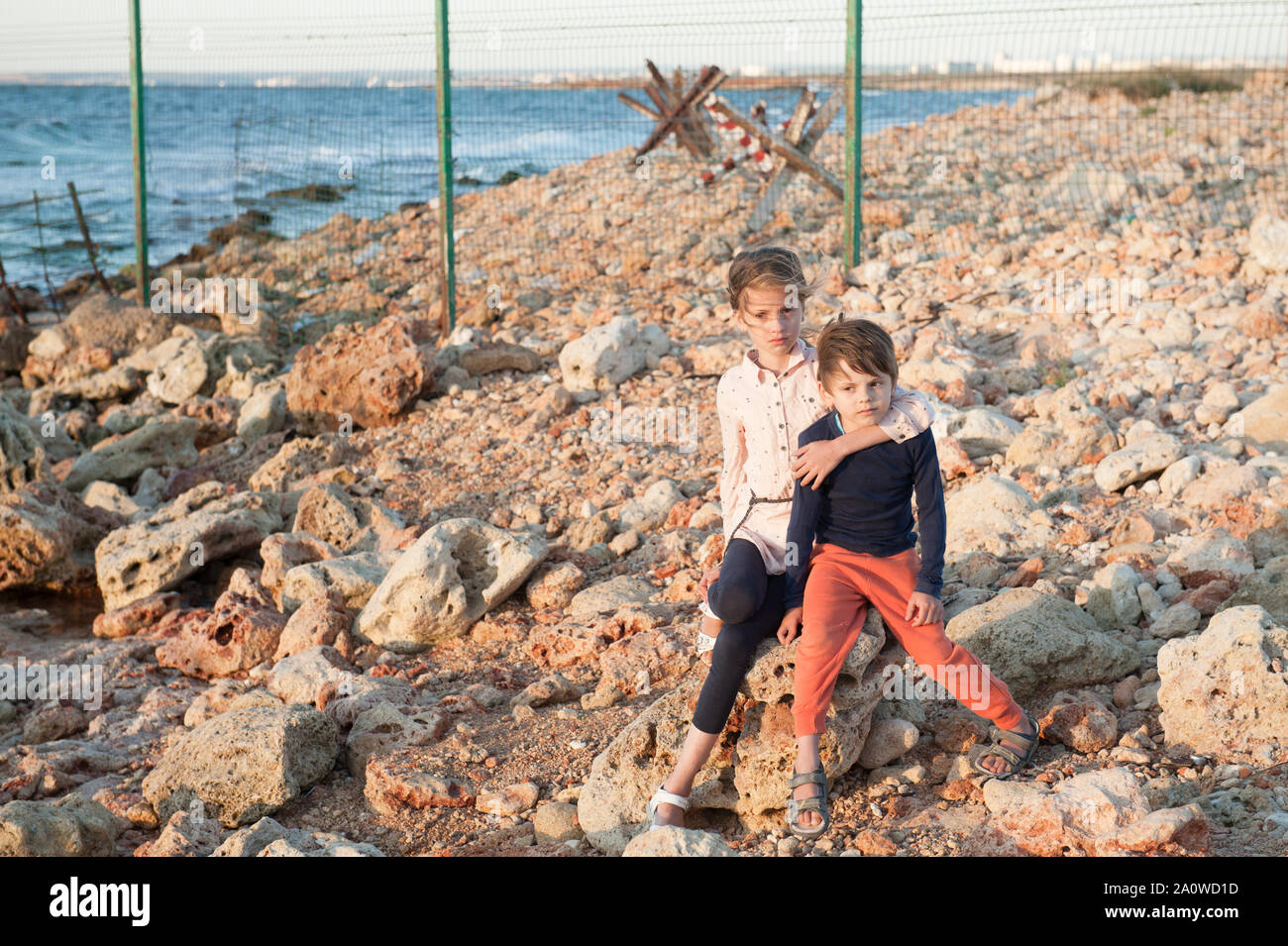 Small girl sitting on stone hi-res stock photography and images - Alamy