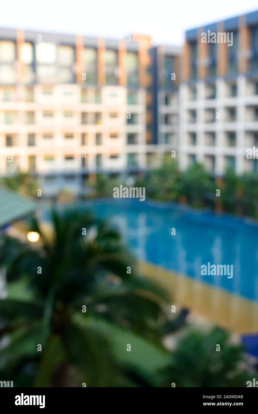 A resort swimming pool view from above. Reflection on water. Defocused ...