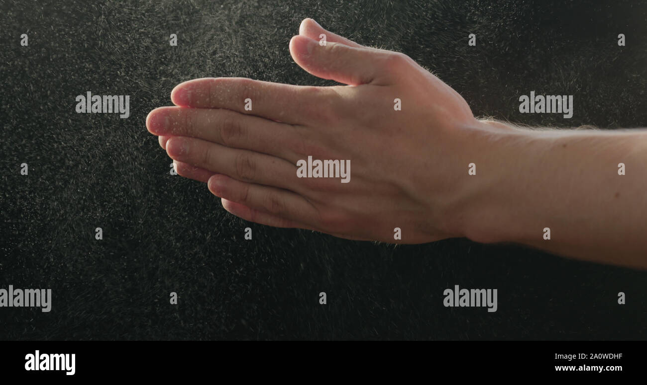 closeup man clapping hands with fine powder, wide photo Stock Photo - Alamy