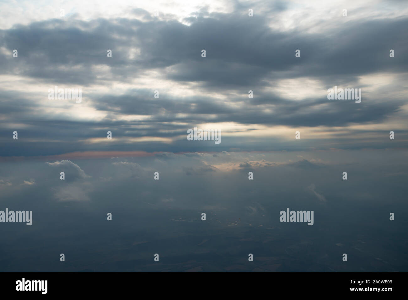 Looking down through dramatic clouds to planet earth Stock Photo - Alamy