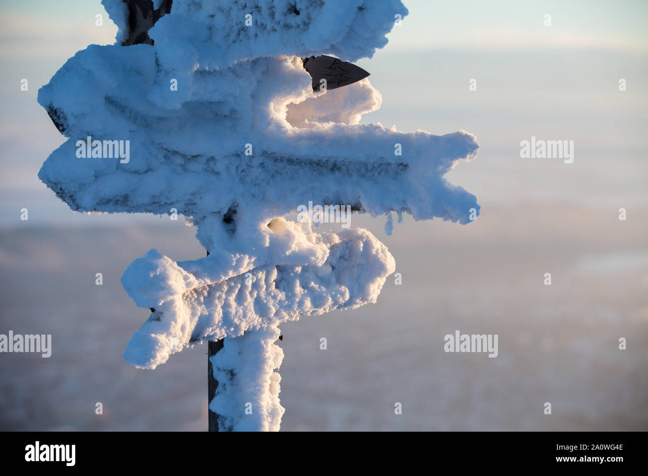 Wooden poles signs are covered with snow and frost Stock Photo - Alamy