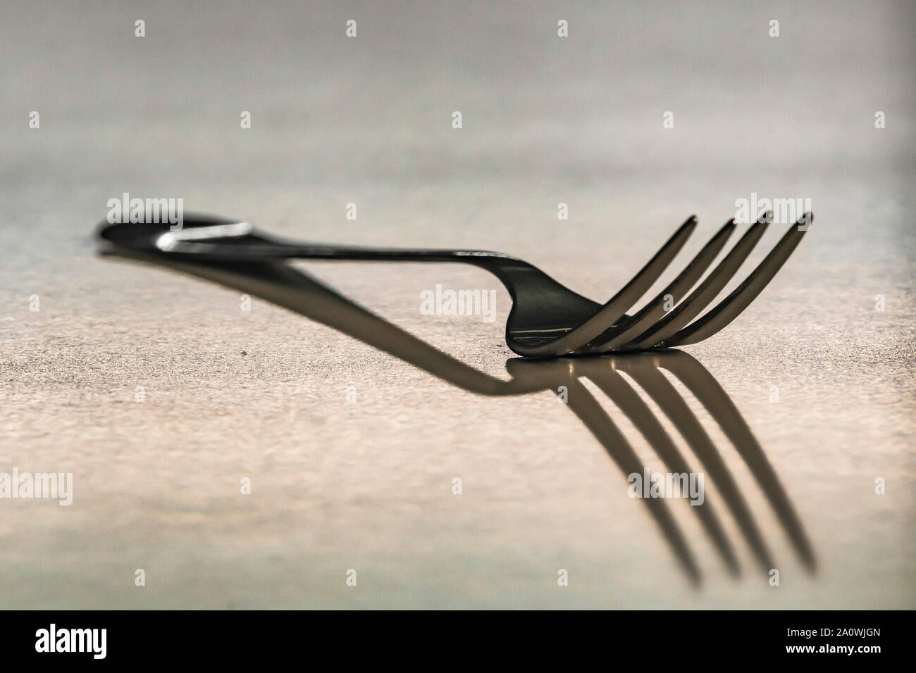 Single fork at the table Stock Photo - Alamy