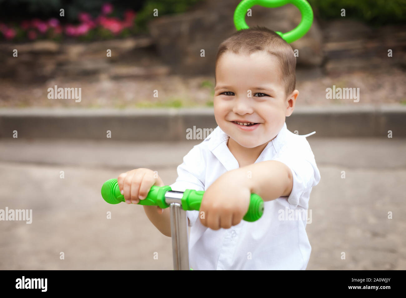 Happy child riding tricycle hi-res stock photography and images - Alamy