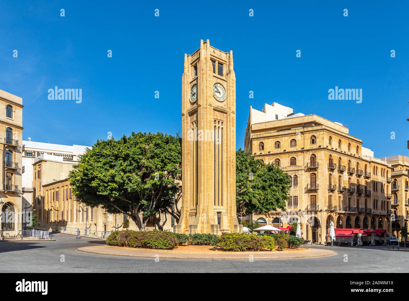 Al-Abed Nejmeh Square clock tower with tree and buildings around ...
