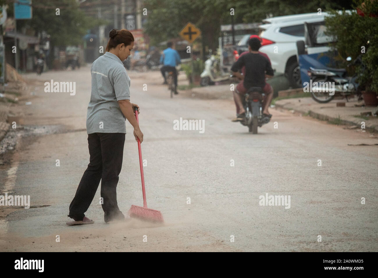 Woman sweeping street hi-res stock photography and images - Alamy