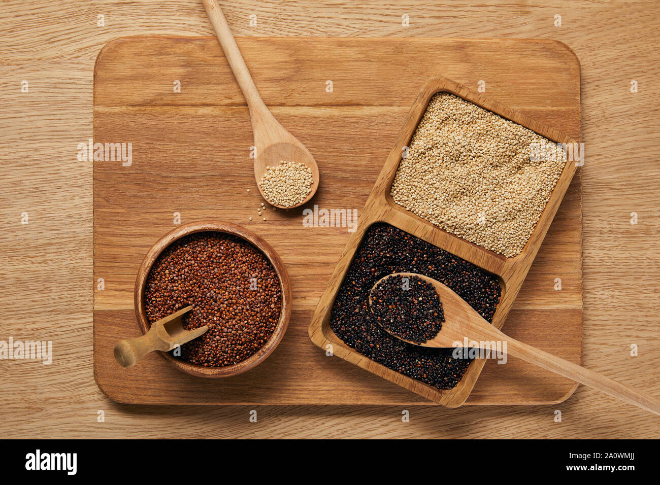 top view of white, black and red quinoa on wooden chopping board Stock ...