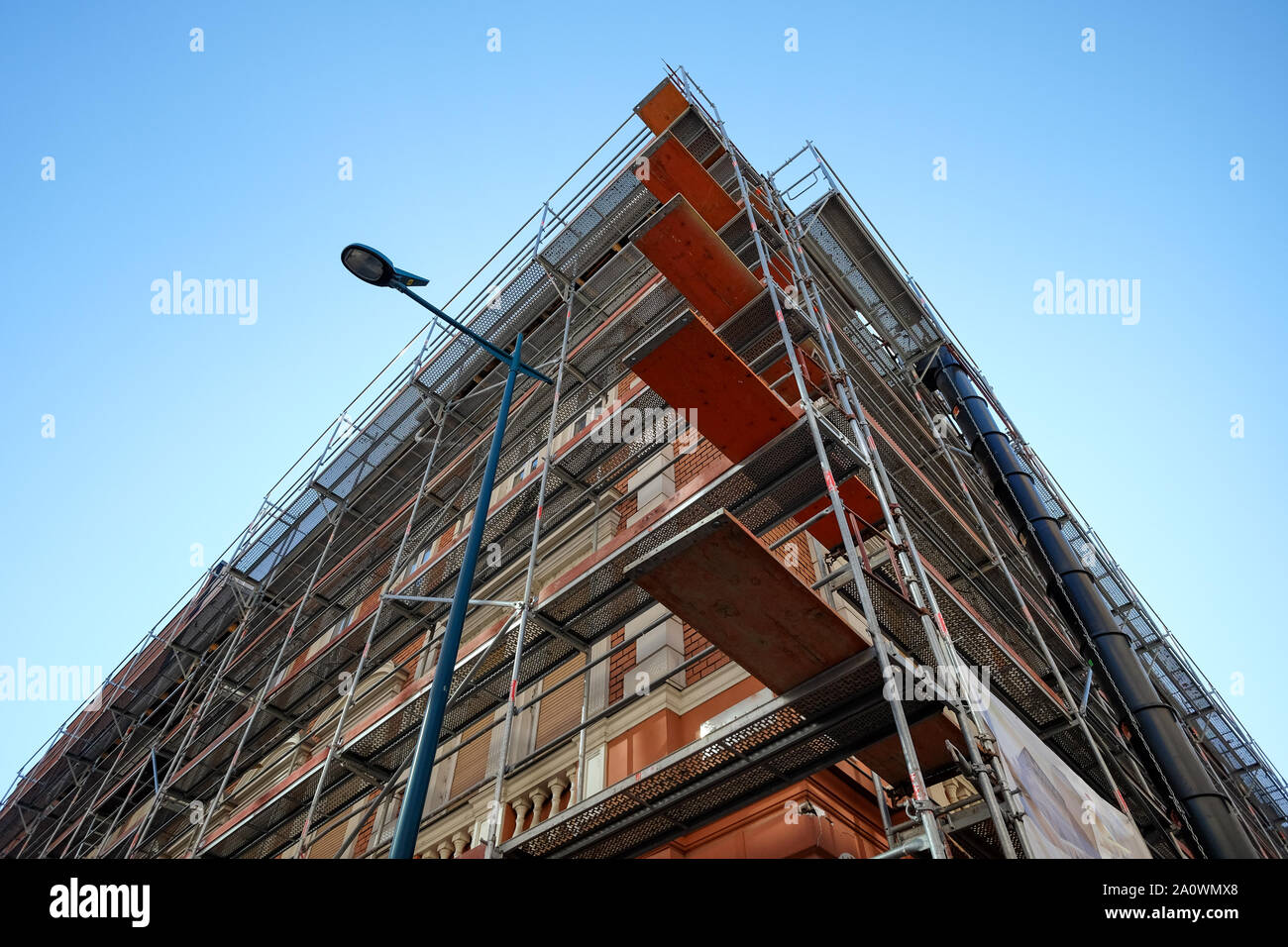 View of scaffolding around historical red brick building Stock Photo ...