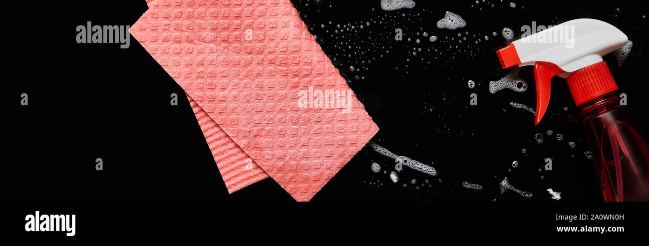 top view of pink rag and bottle with spray on black background Stock ...