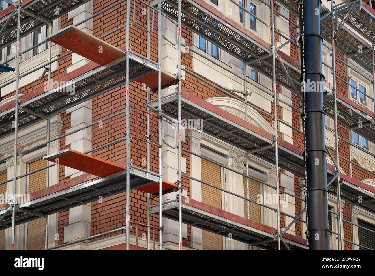 Renovation metal scaffolding around red brick old building Stock Photo ...