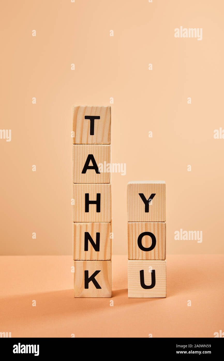 wooden blocks with thank you lettering on table isolated on beige Stock ...