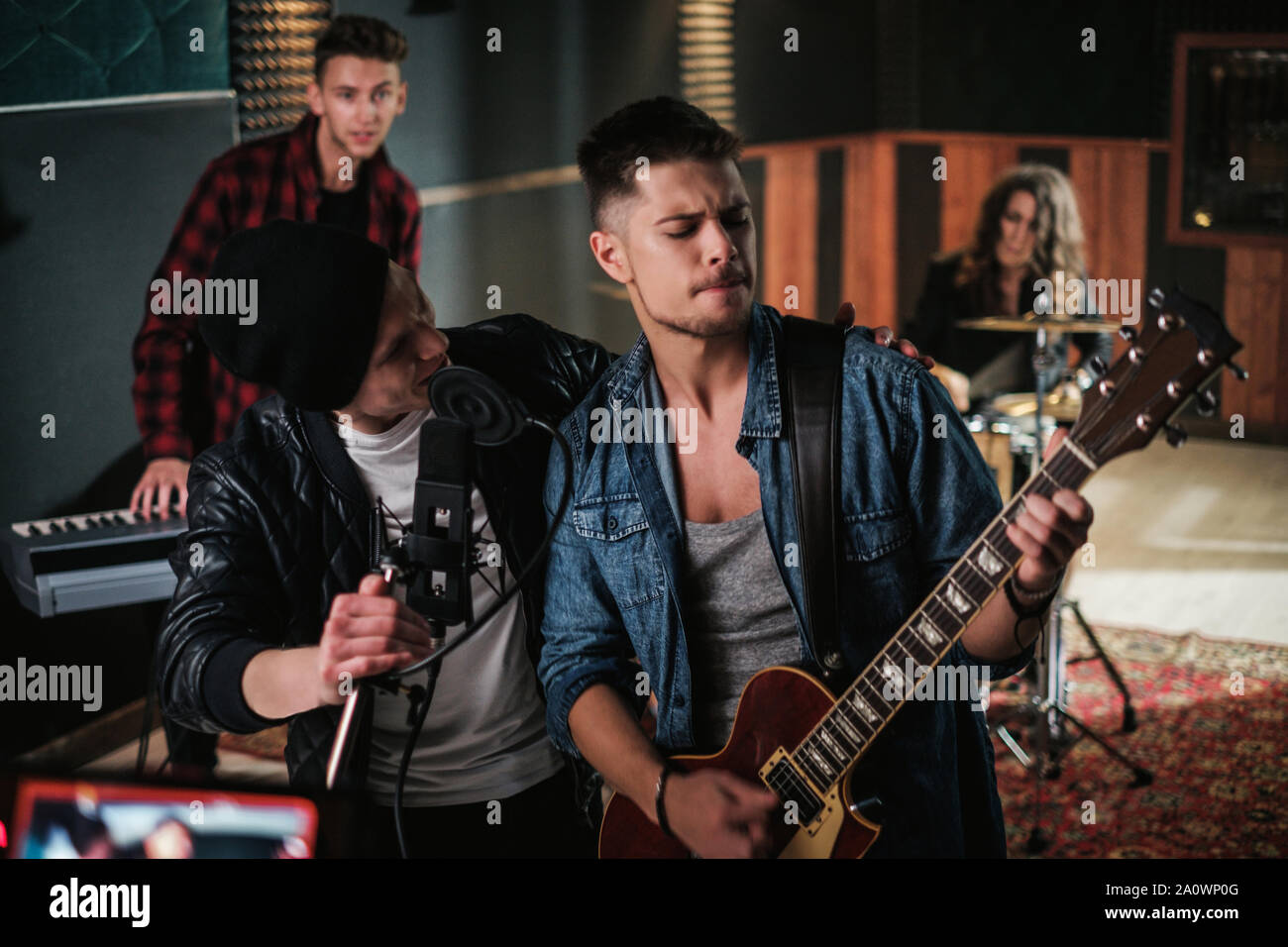 Music band having rehearsal in a studio Stock Photo - Alamy