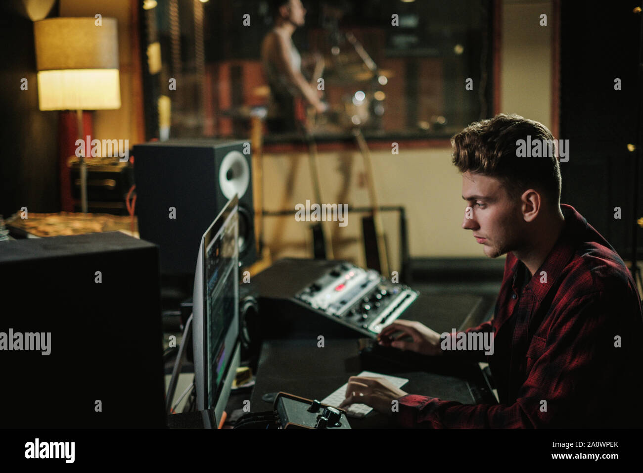 Sound engineer working in a music studio Stock Photo - Alamy