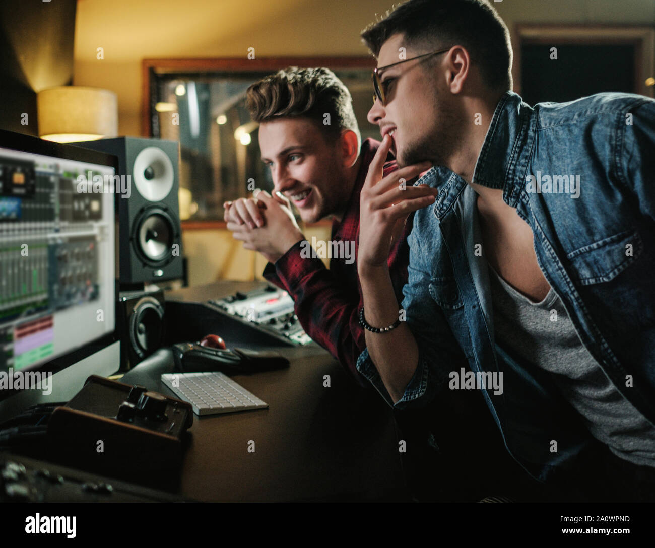 Sound engineer working in a music studio Stock Photo - Alamy
