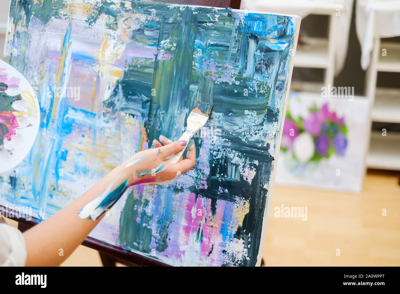 Creative painter paints a colorful picture in her studio Stock Photo ...