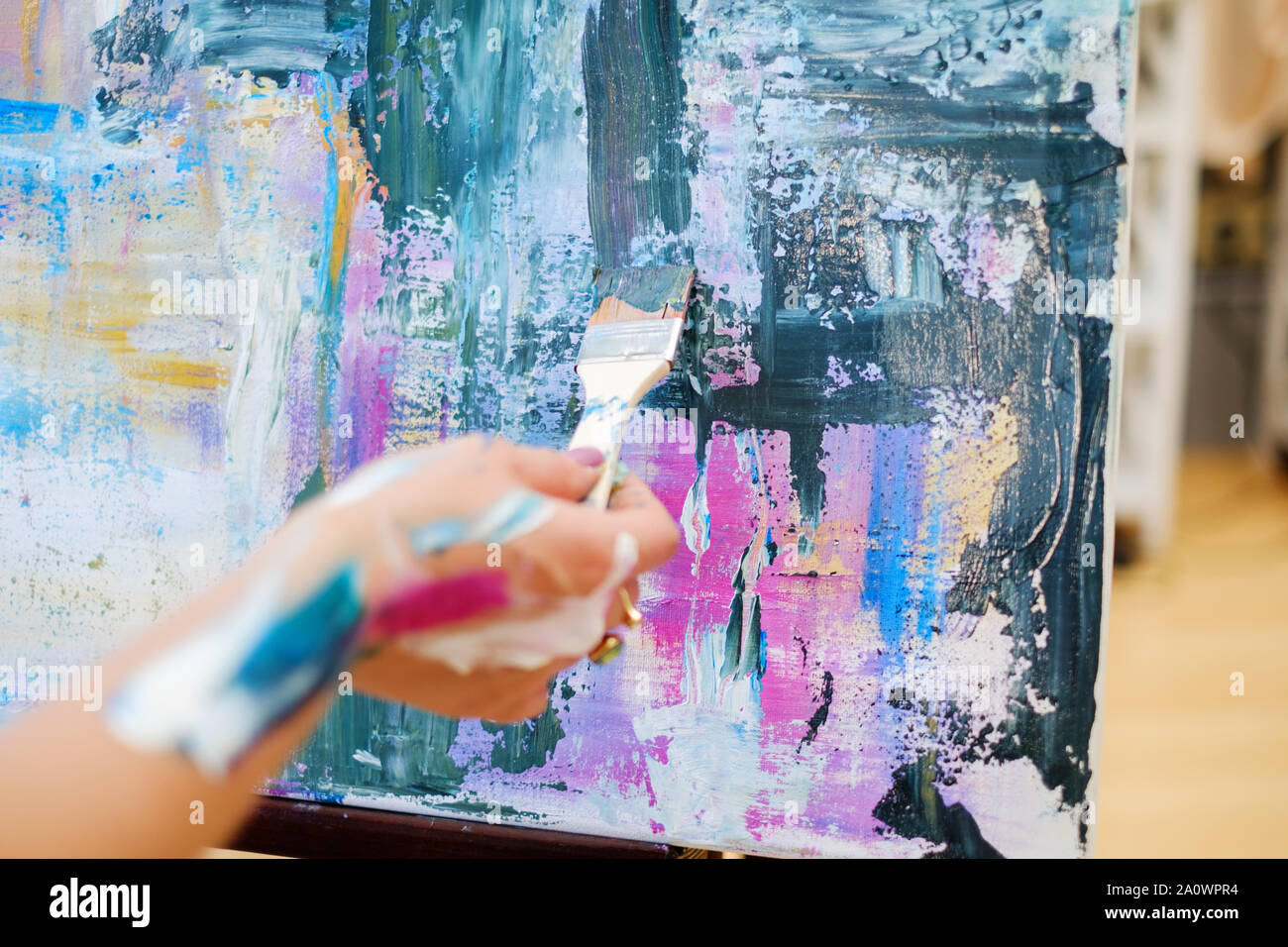 Creative painter paints a colorful picture in her studio Stock Photo ...