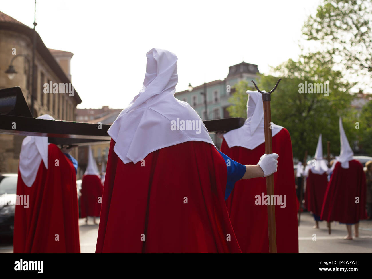 Rear view of hooded penitents in a procession, Holy Week Stock Photo ...