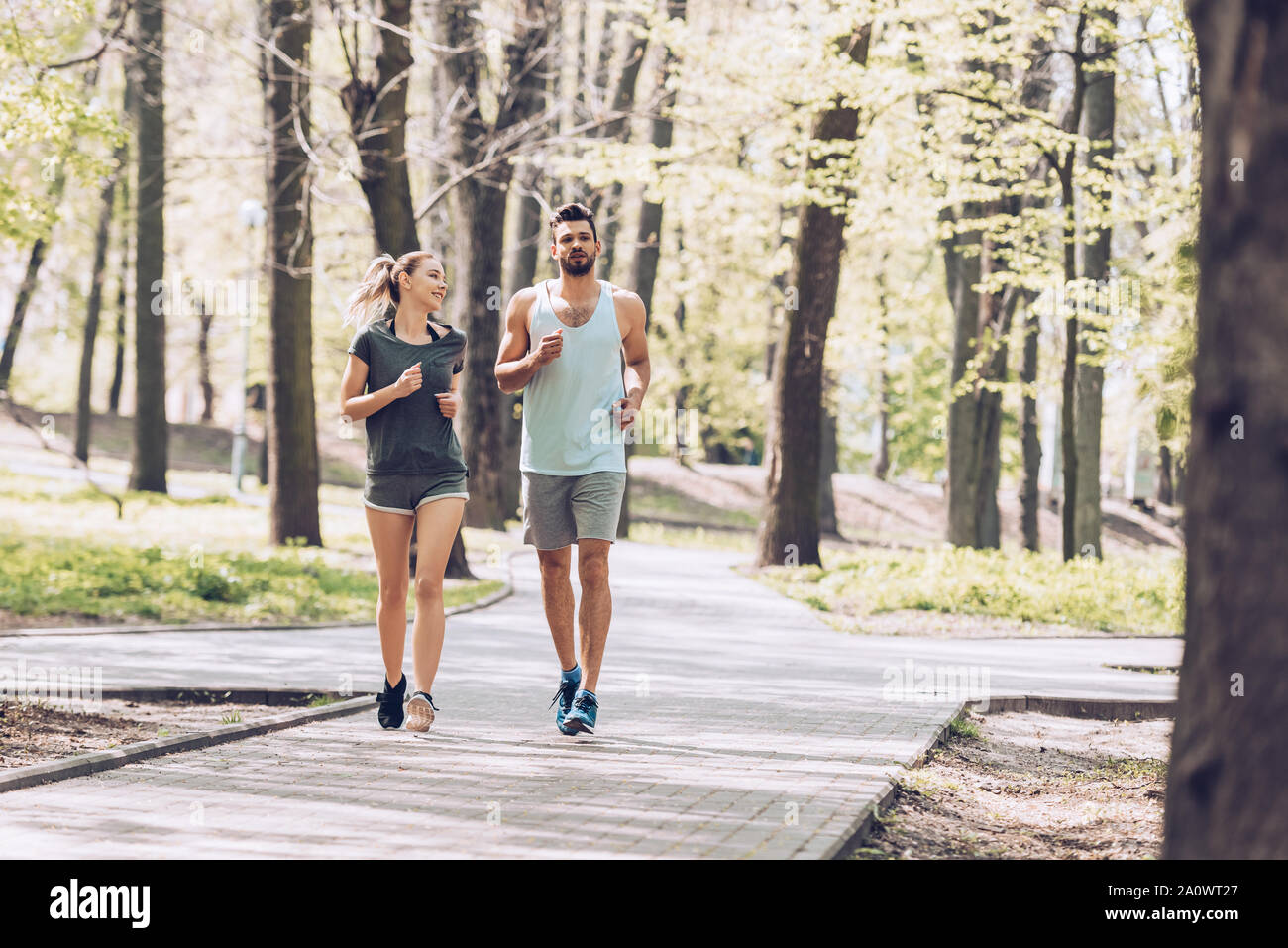 Joggers running green park hi-res stock photography and images - Alamy