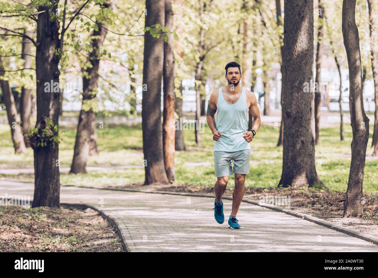 Handsome sportsman jogging along hi-res stock photography and images ...