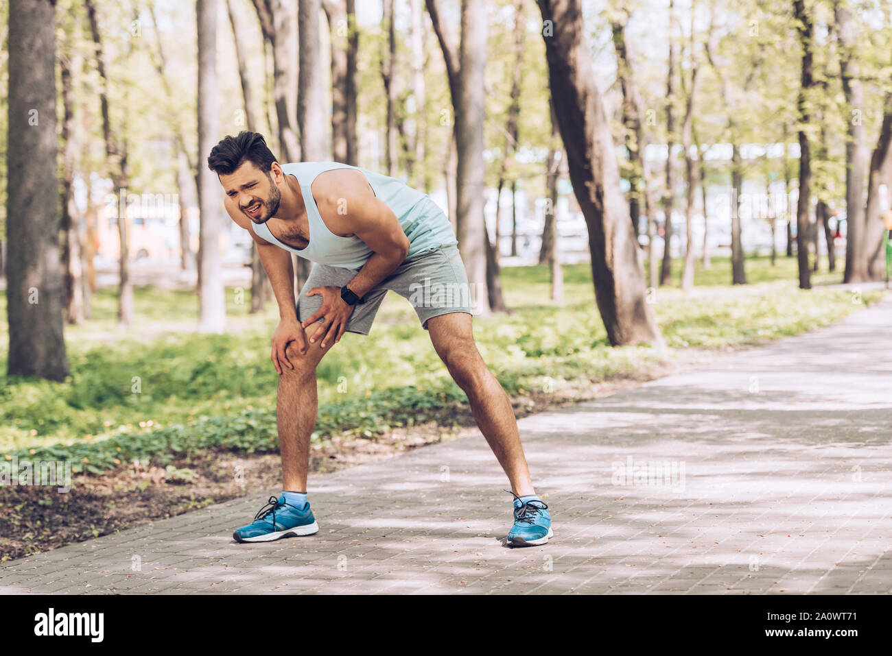 Man touching his leg outside hi-res stock photography and images - Alamy
