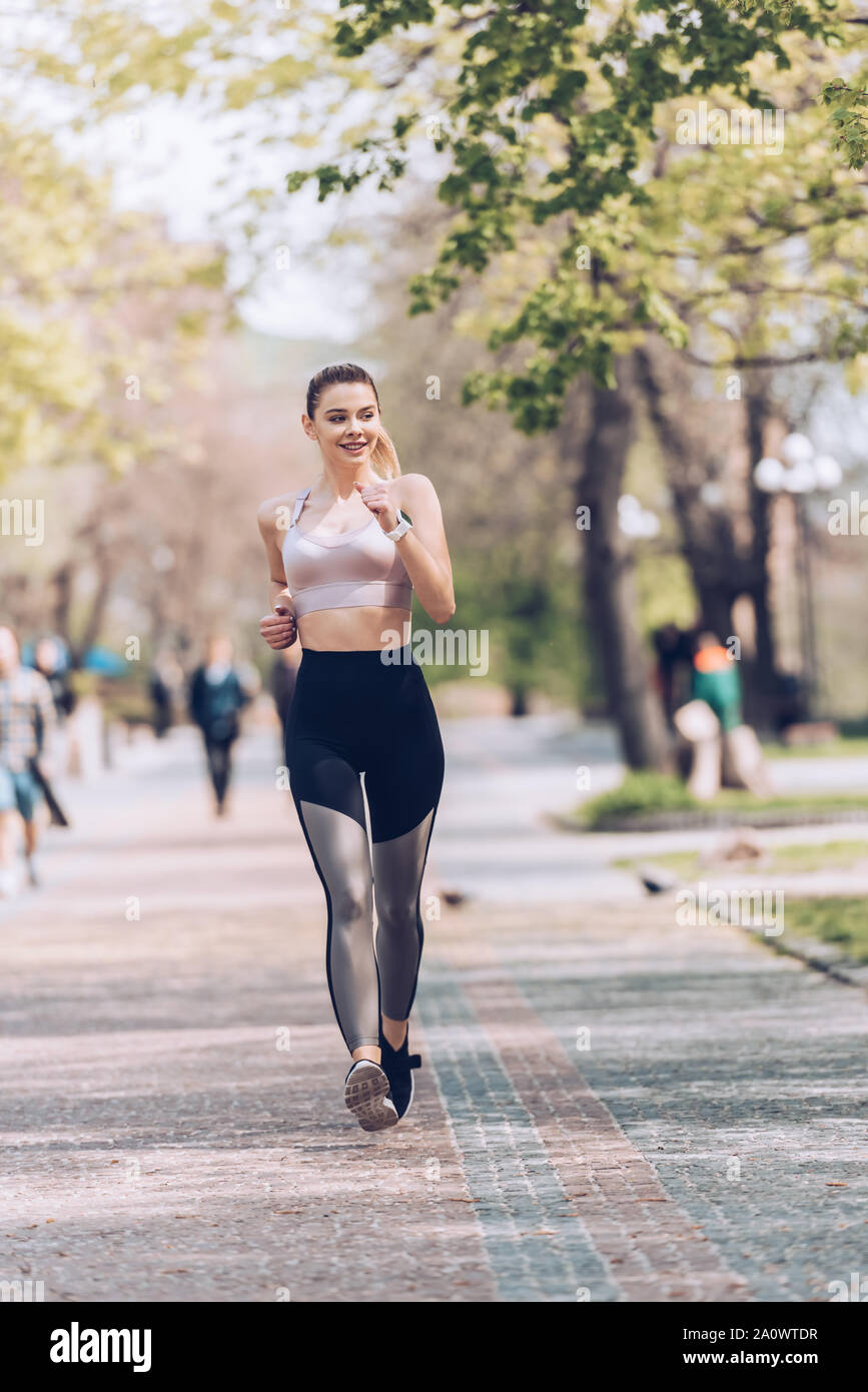 Beautiful woman running along walkway hi-res stock photography and ...