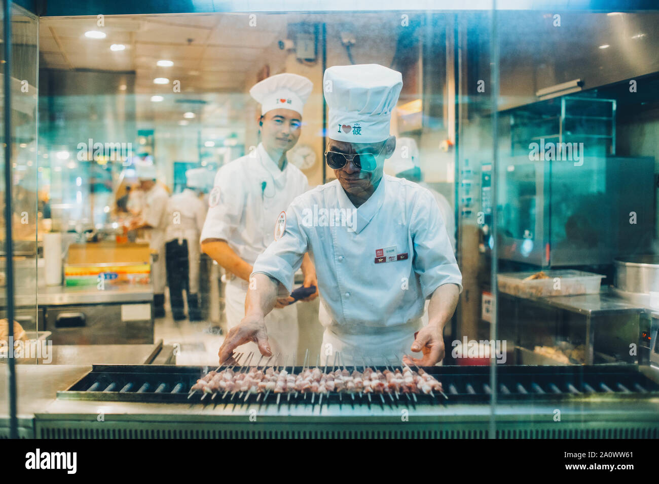 Elder staff preparing food in a chinese restant of a shopping mall in ...