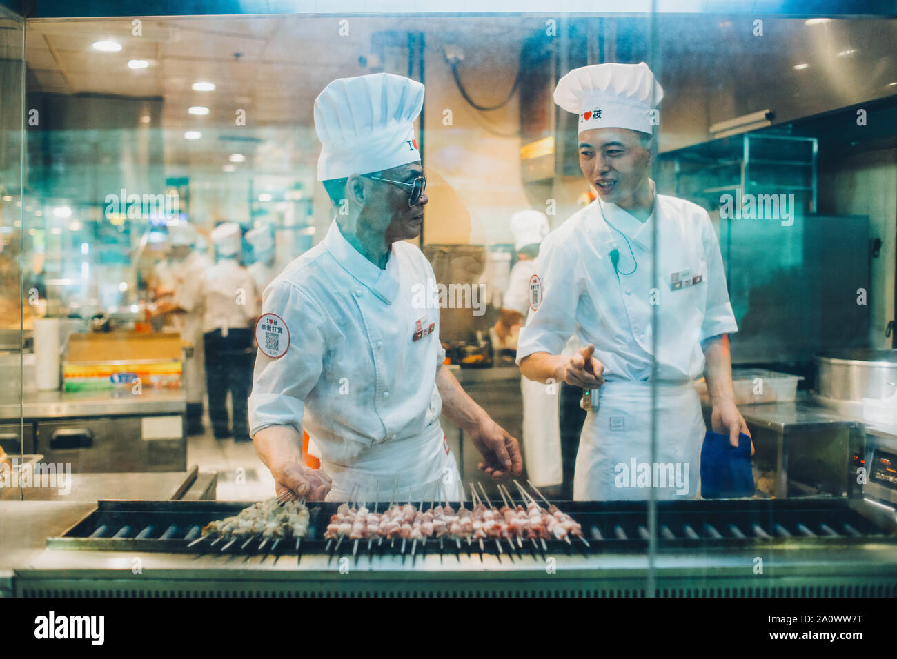 Elder staff preparing food in a chinese restant of a shopping mall in ...