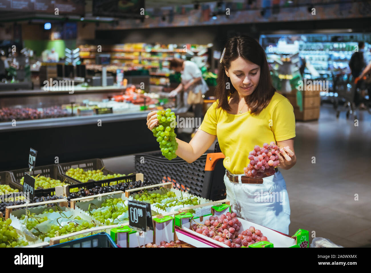 Female buyer choosing grapes hi-res stock photography and images - Alamy