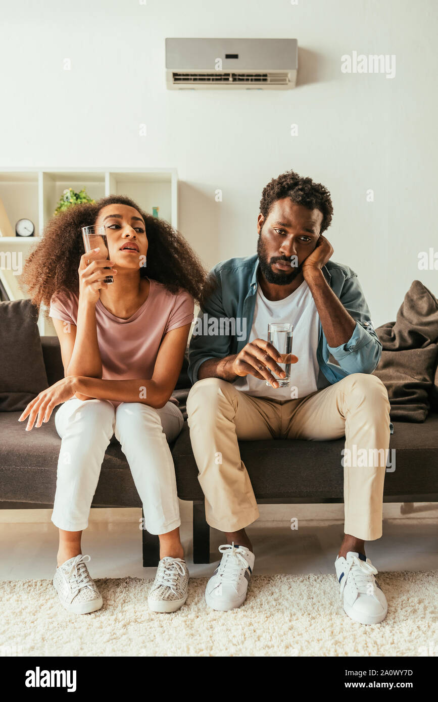 exhausted african america man and woman suffering from summer heat and ...