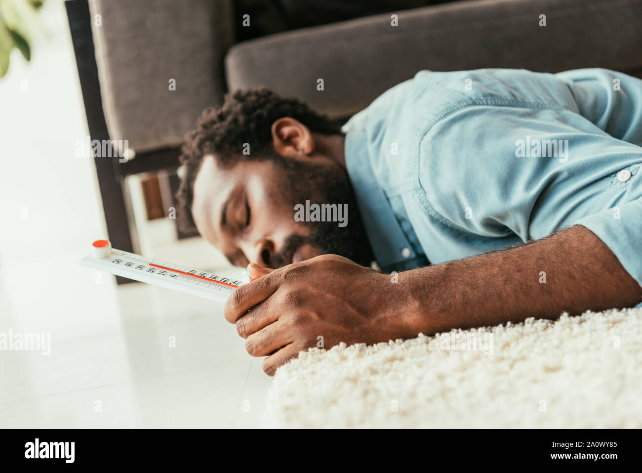 exhausted african american man suffering from summer heat while lying ...